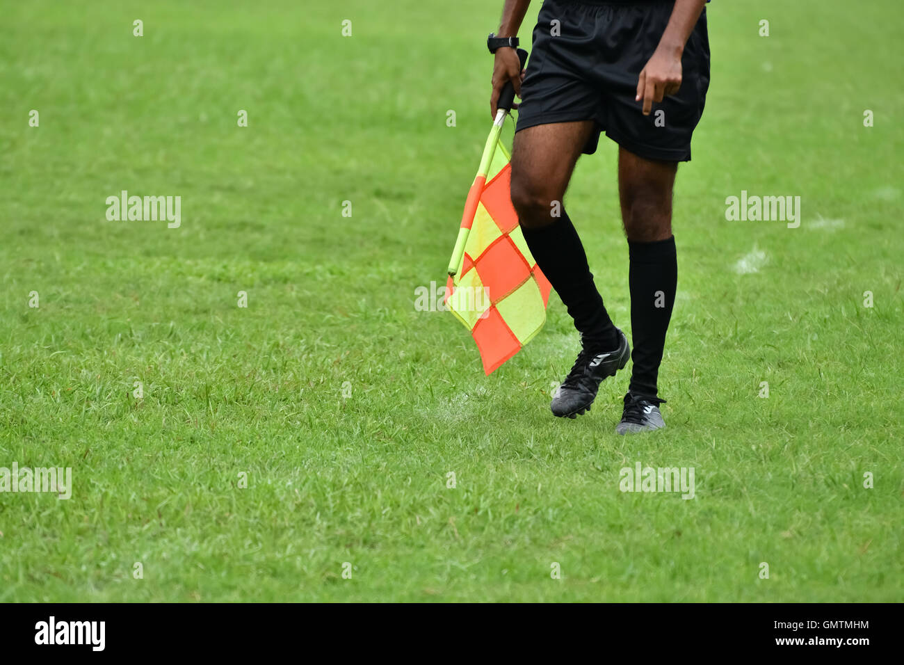 Assistant referee running along the sideline Stock Photo - Alamy