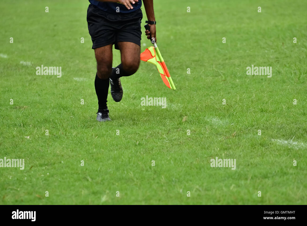 Assistant referee running along the sideline Stock Photo - Alamy