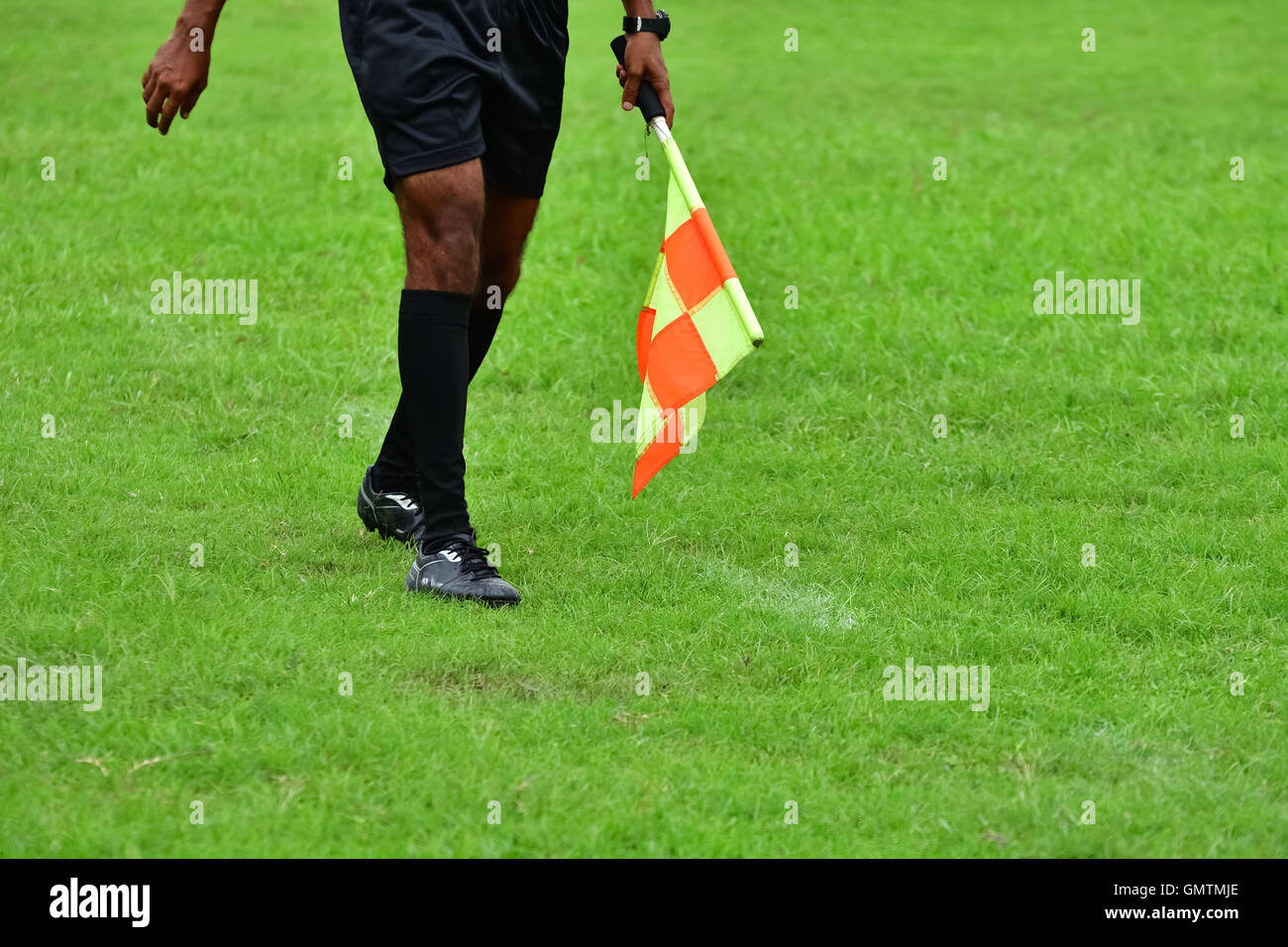 Assistant referee running along the sideline Stock Photo - Alamy
