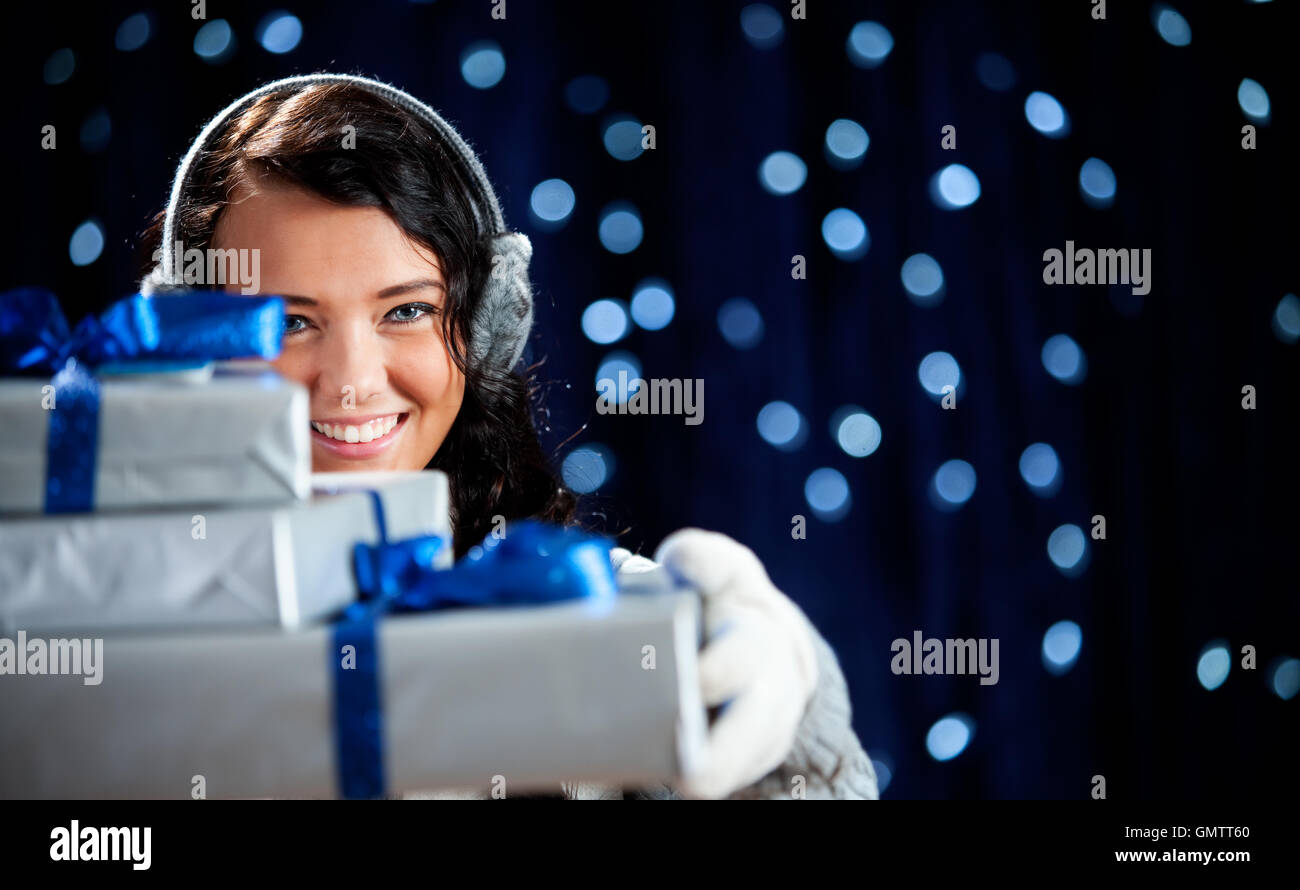Pretty Caucasian girl in winter clothing on a blue background with ...