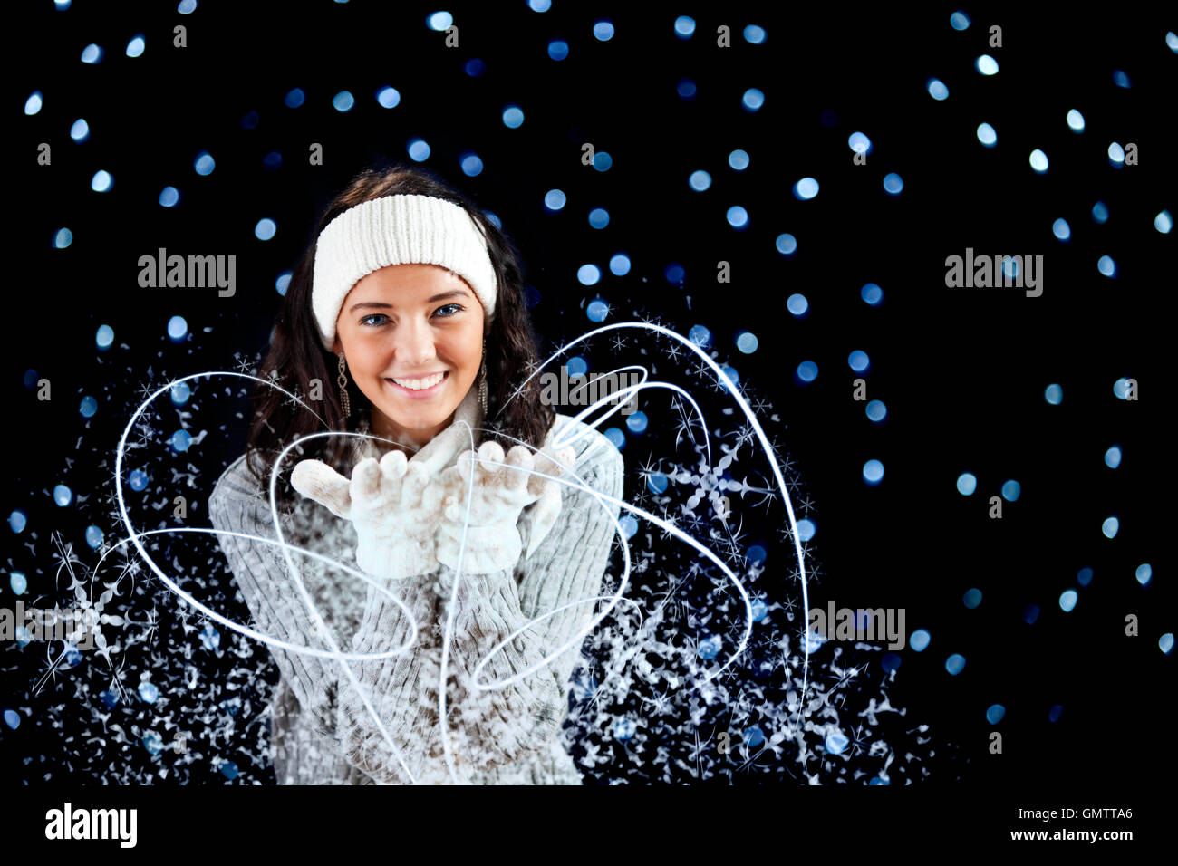 Pretty Caucasian girl in winter clothing on a blue background with ...