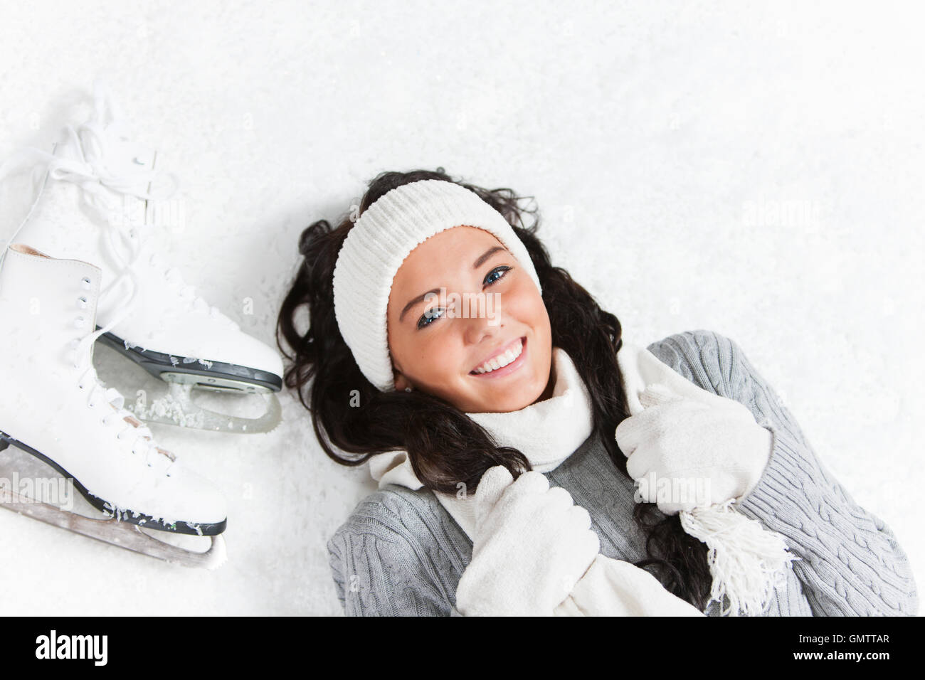 Pretty Caucasian girl in winter clothing on a blue background with ...