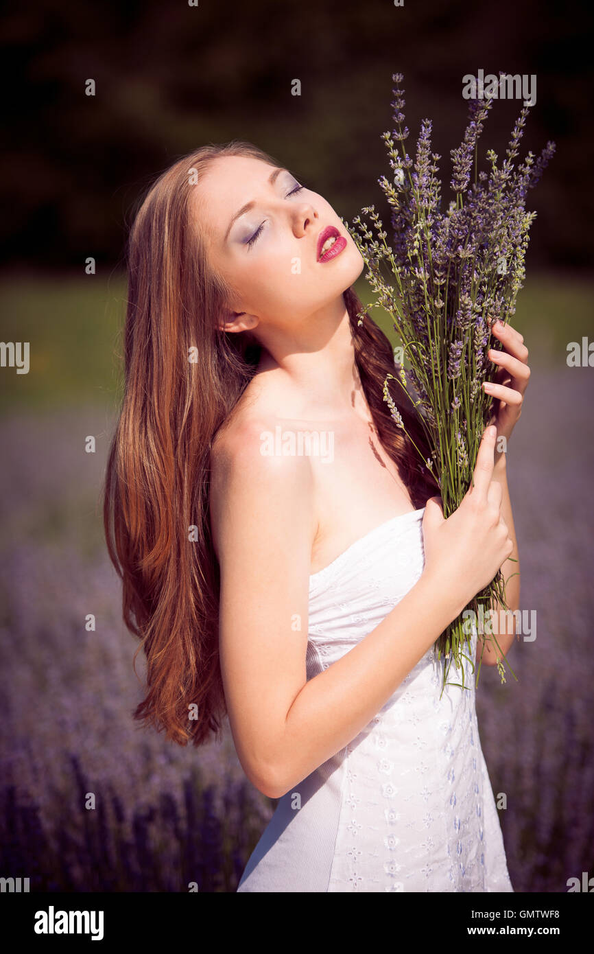 Beautiful young woman on lavender field Stock Photo - Alamy