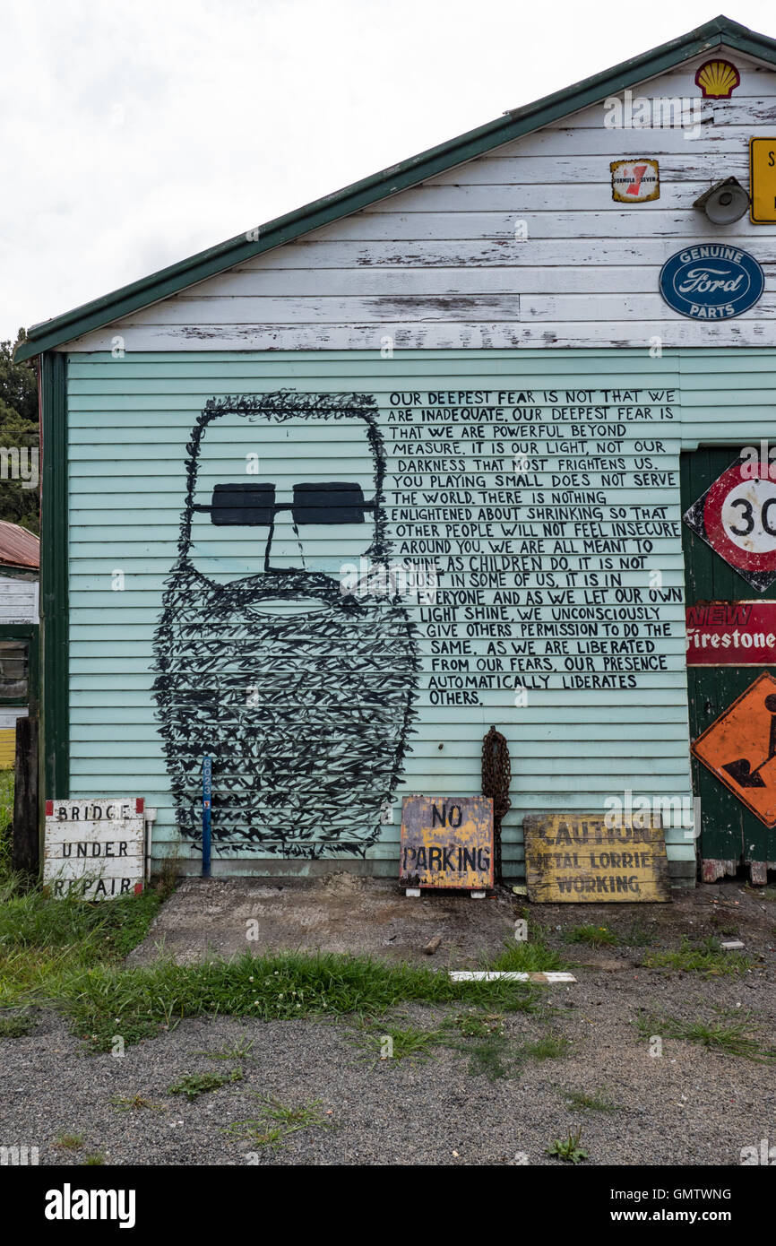 Graffiti and 30 speed limit traffic signs on an old barn. Whangamomona ...