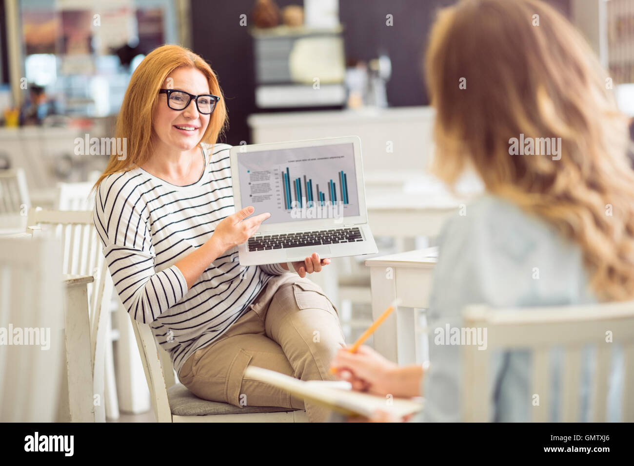 Cheerful woman presenting her project Stock Photo - Alamy