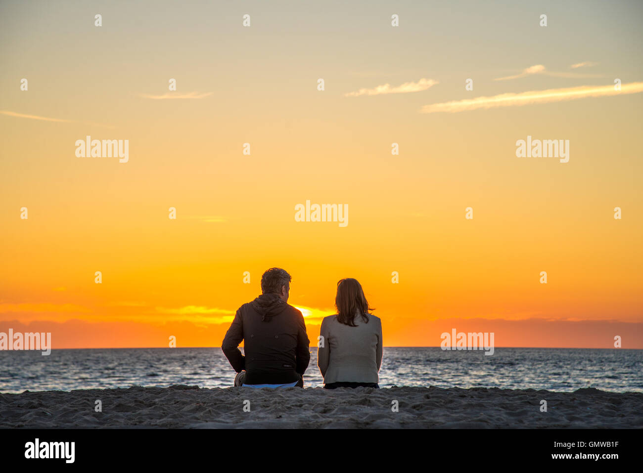 Couple watching a sunset sky hi-res stock photography and images - Alamy