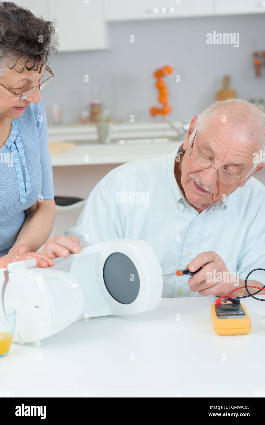 Elderly man testing cafetiere with multimeter Stock Photo - Alamy