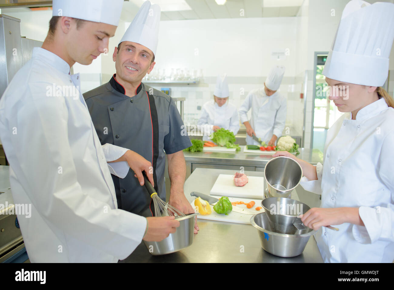 Chef supervising trainees Stock Photo - Alamy