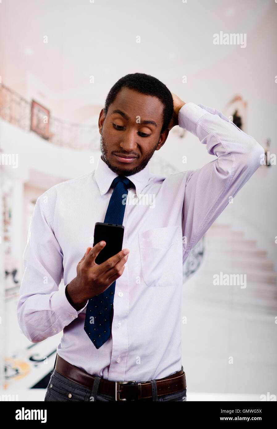 Handsome Man Wearing Shirt And Tie Posing Holding Mobile Phone In Hand
