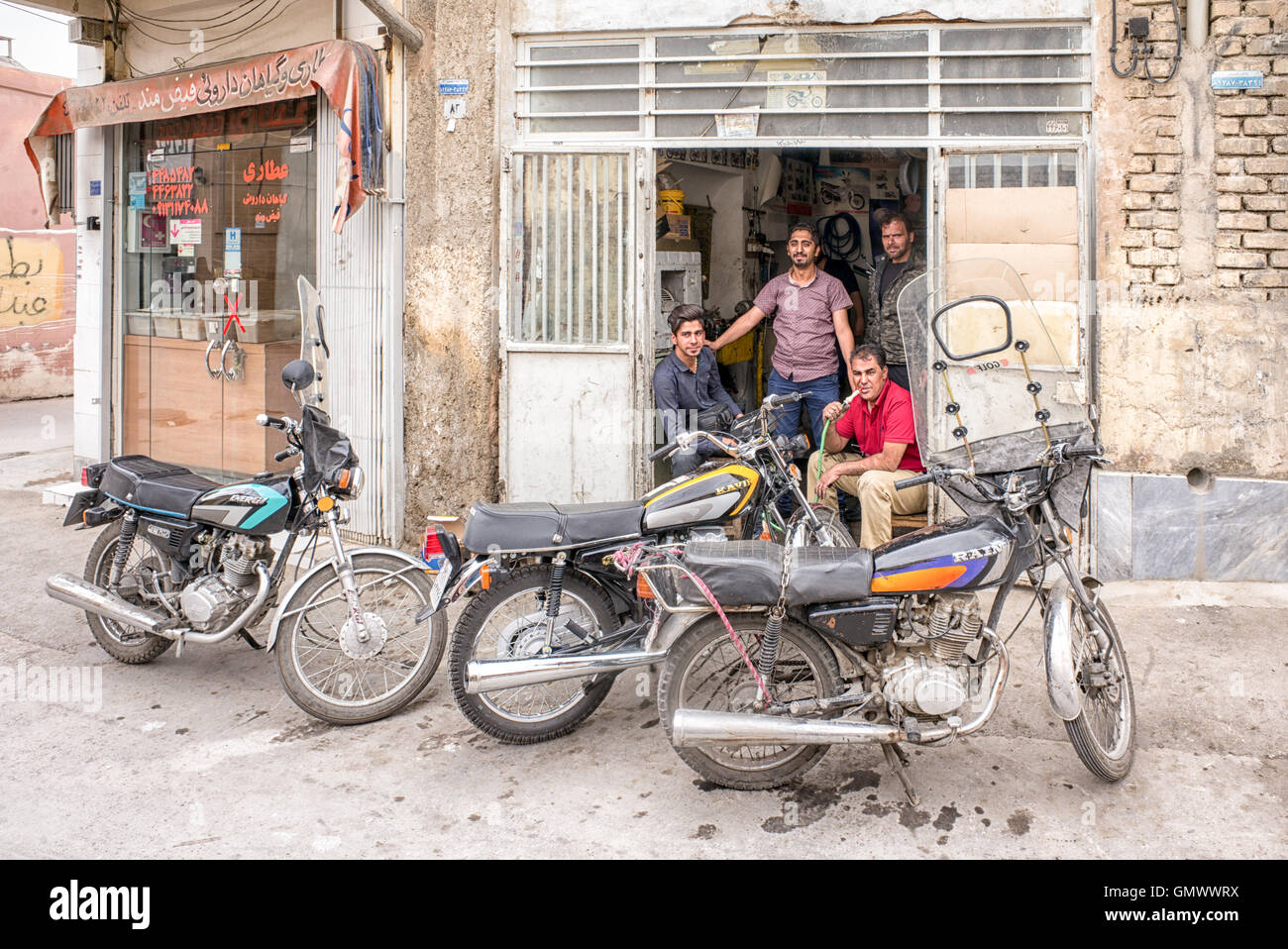 Iranian friends hanging out at motorbike repair shop in Isfahan, Iran ...