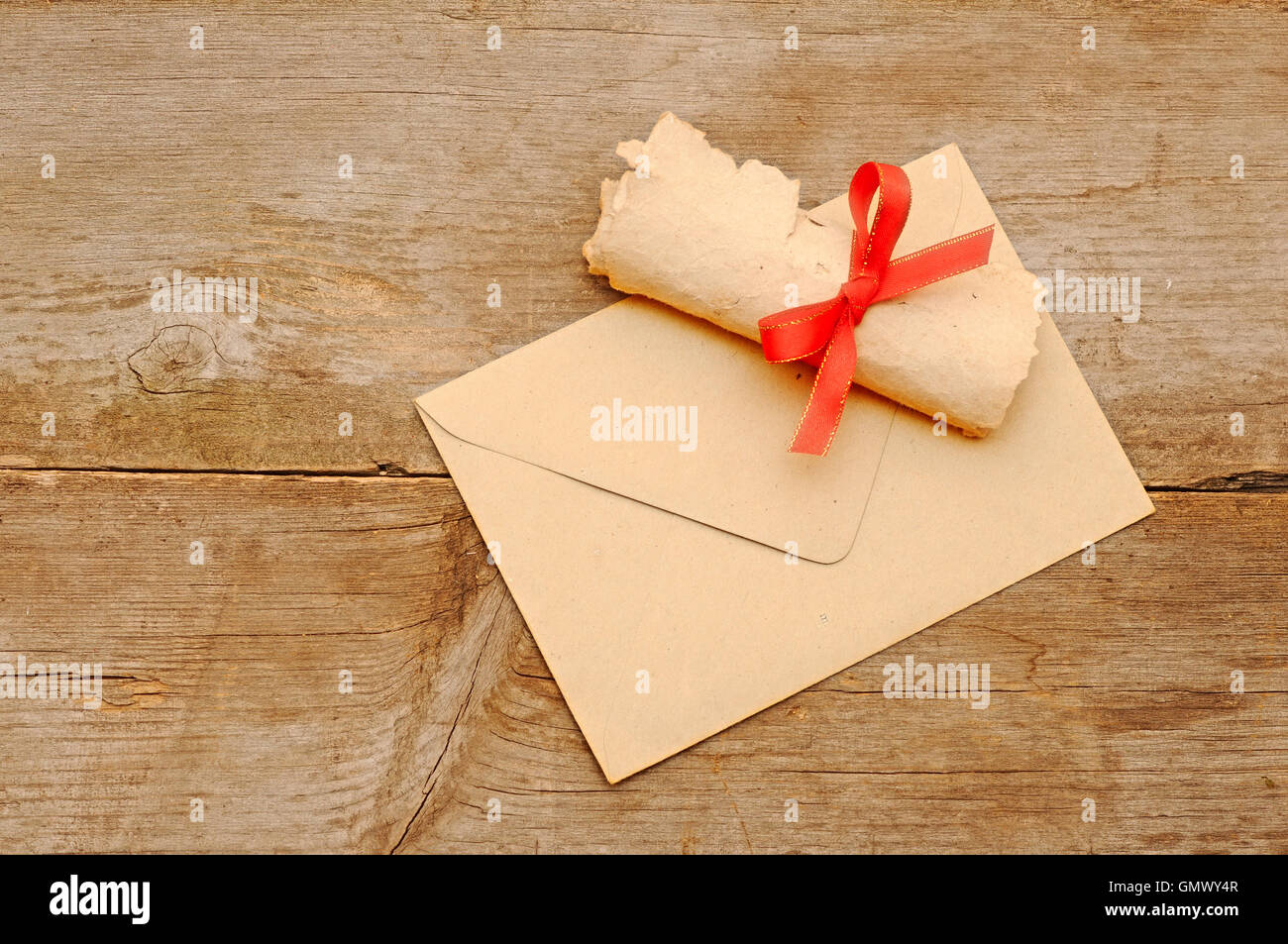 envelope old paper roll over wood background Stock Photo - Alamy