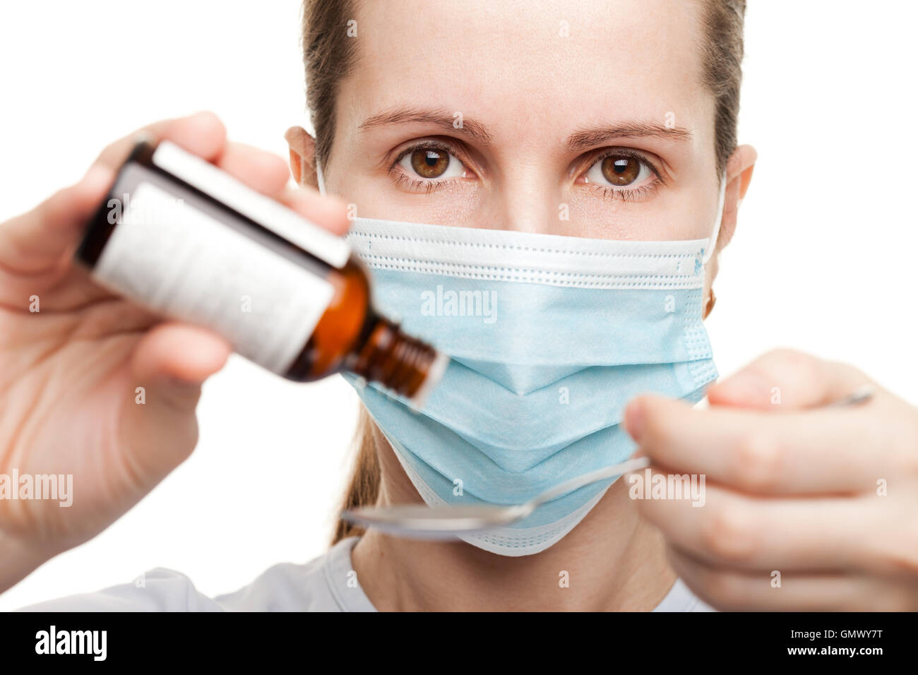Doctor in mask holding medicine syrup Stock Photo - Alamy
