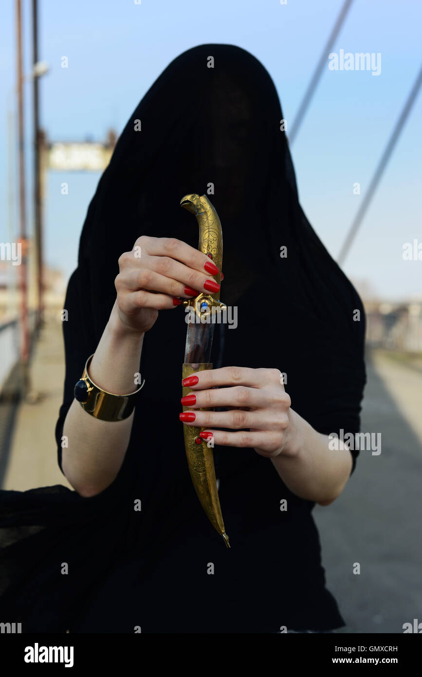 Girl in black with an oriental dagger Stock Photo - Alamy