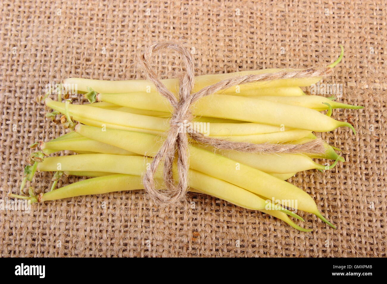 Stack of beans tied with string lying on jute canvas, healthy food and ...
