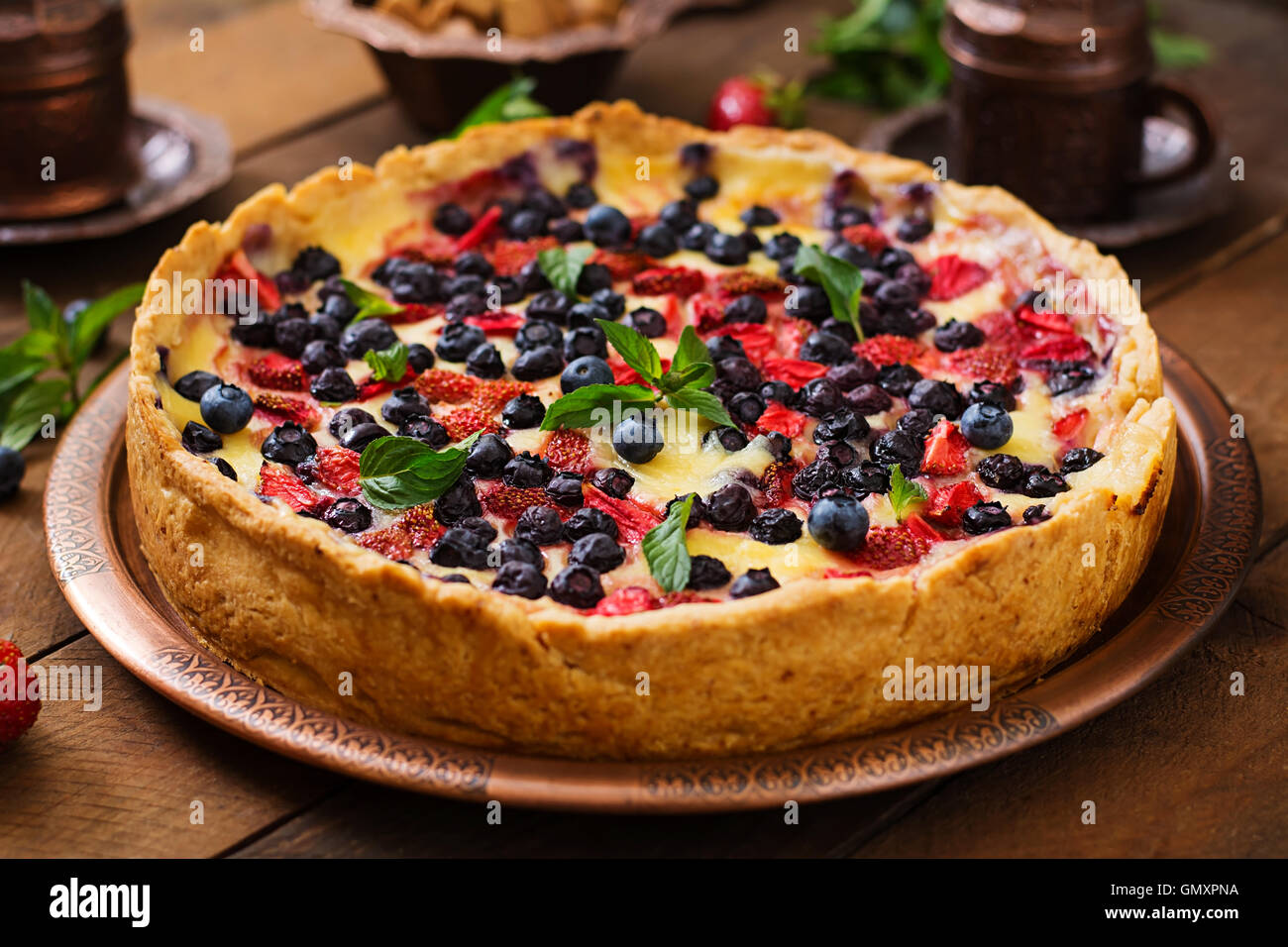French tart (flan) with berries and custard Stock Photo - Alamy