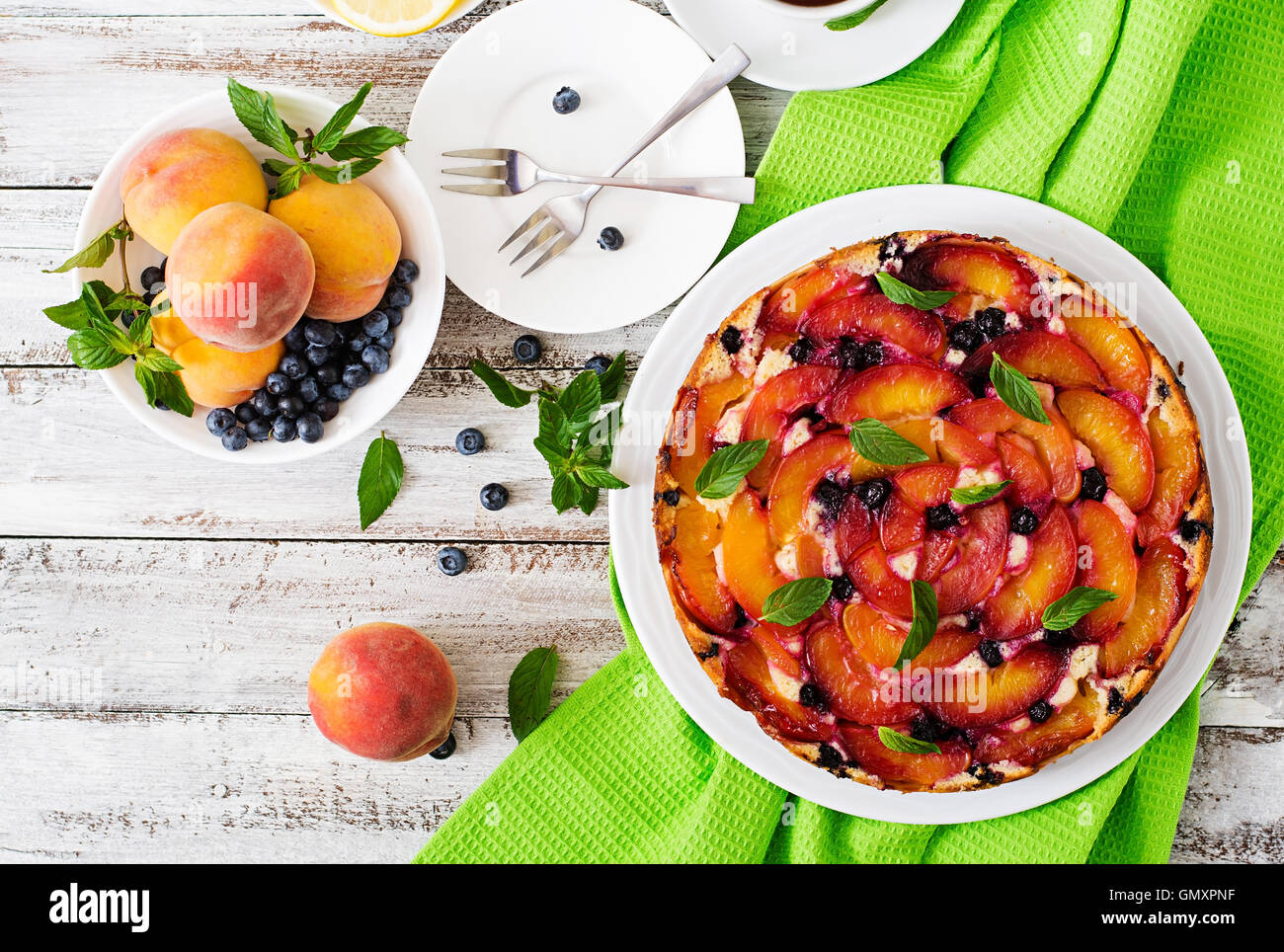 Delicate biscuit pie with peaches and blueberries. Top view Stock Photo ...