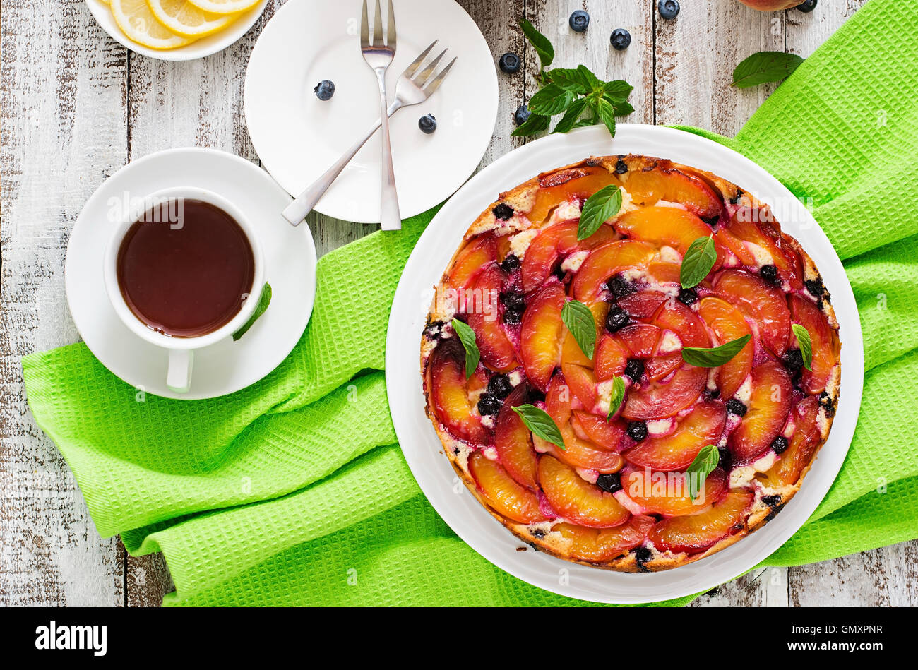Delicate biscuit pie with peaches and blueberries. Top view Stock Photo ...