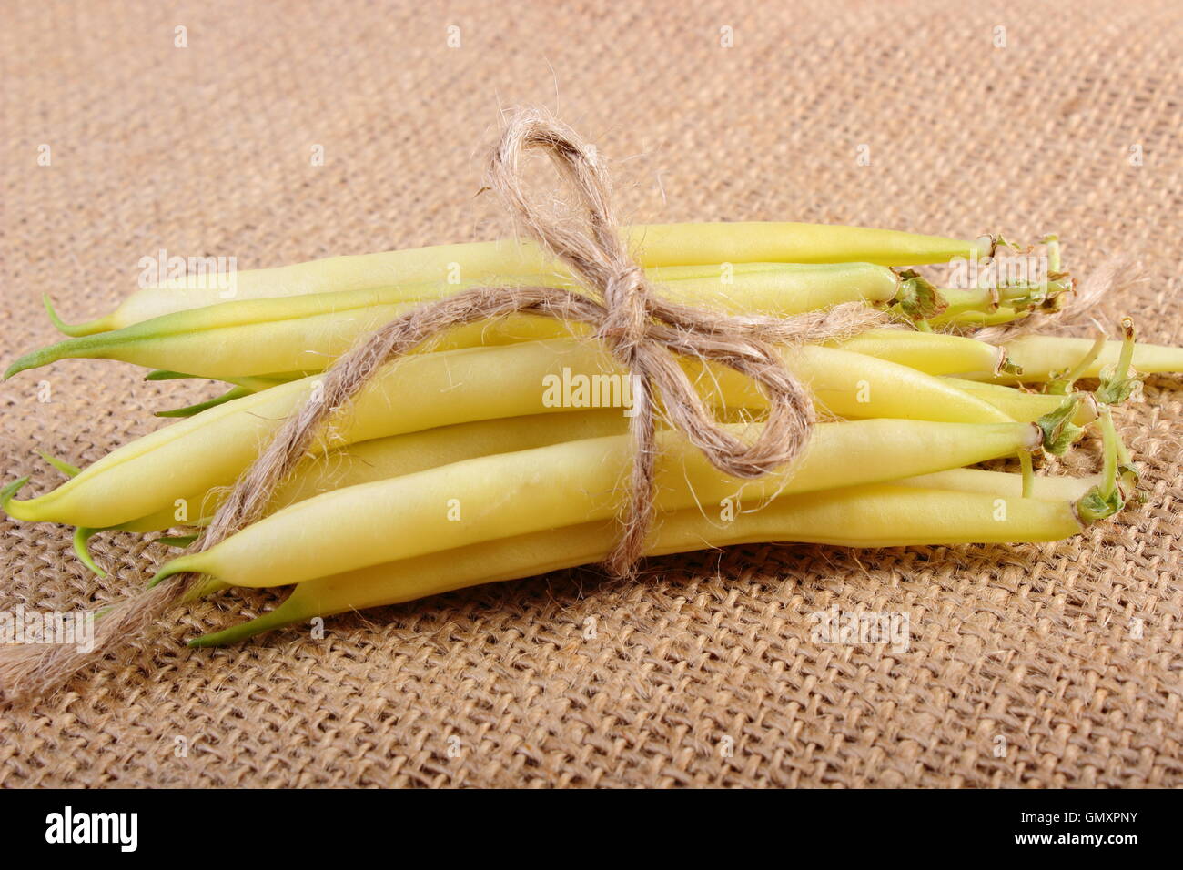 Stack of beans tied with string lying on jute canvas, healthy food and ...