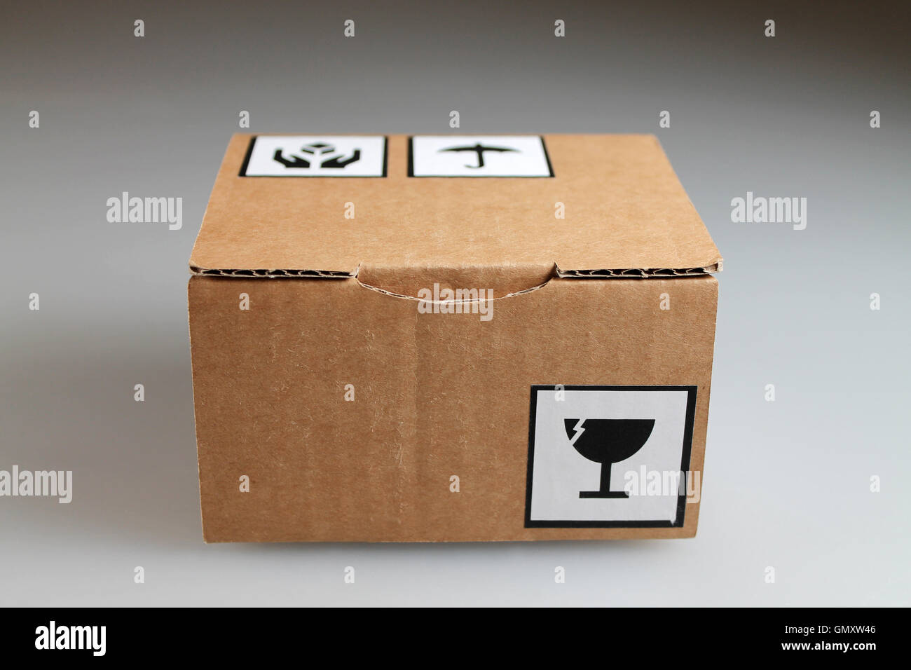 Carton box with fragile symbol Stock Photo - Alamy