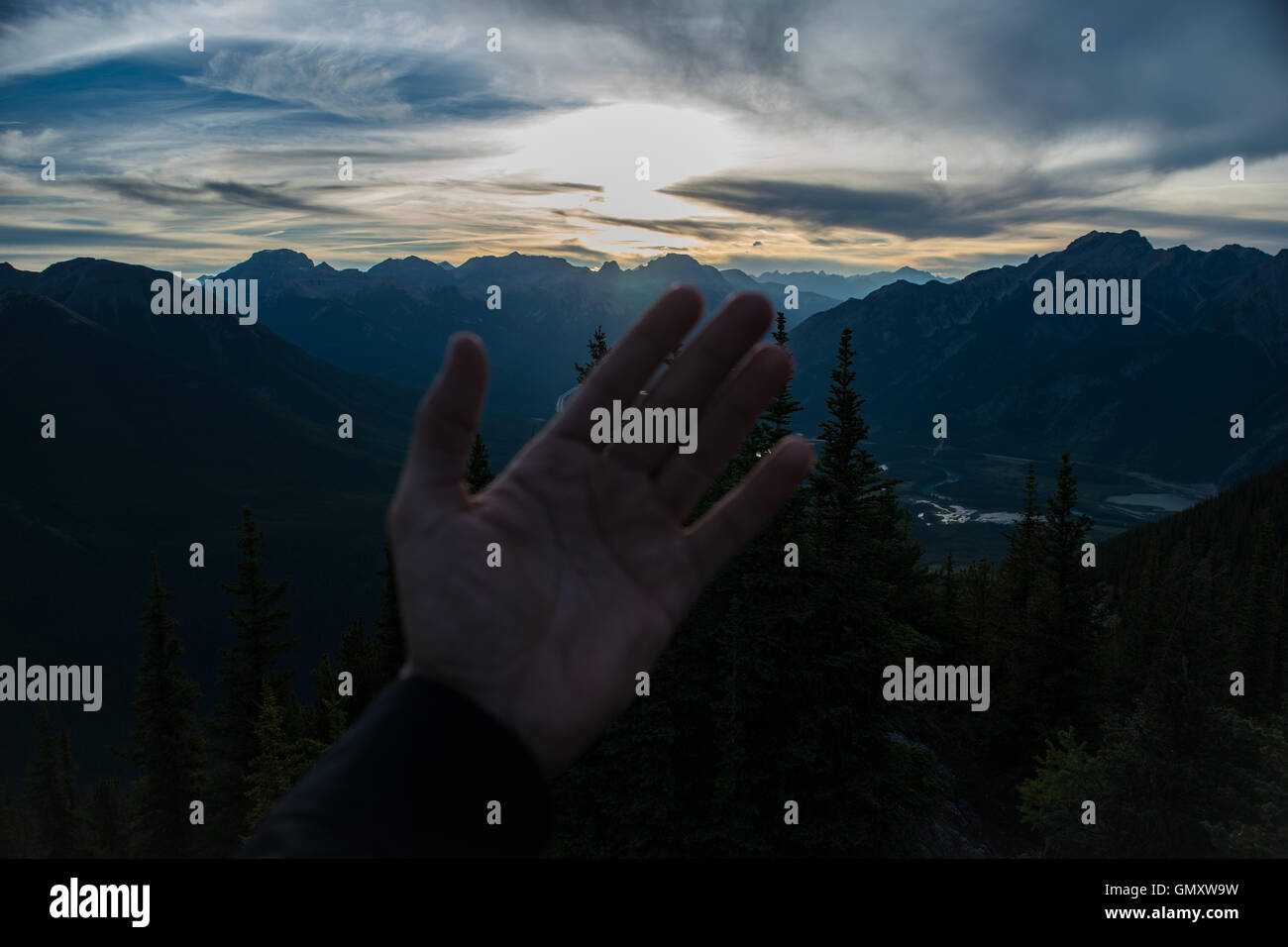 The hand behind the mountains Stock Photo - Alamy