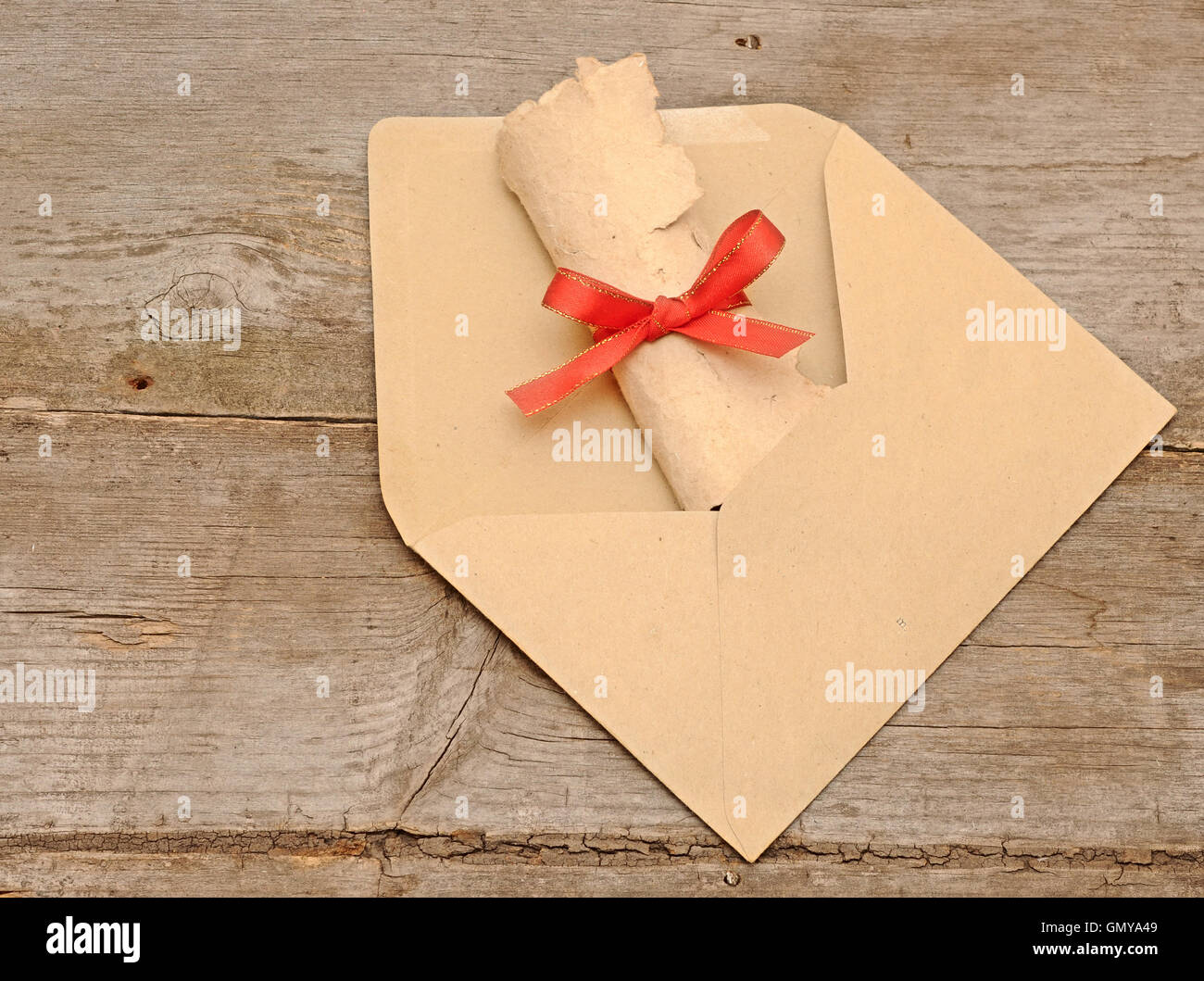 envelope old paper roll over wood background Stock Photo - Alamy