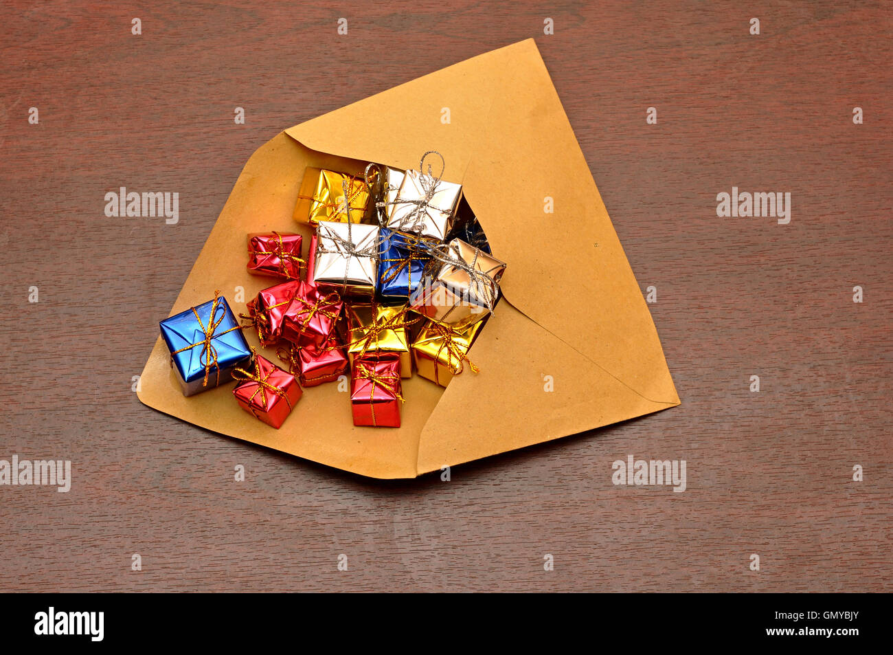 colorful gift boxes with envelope on wood background Stock Photo - Alamy