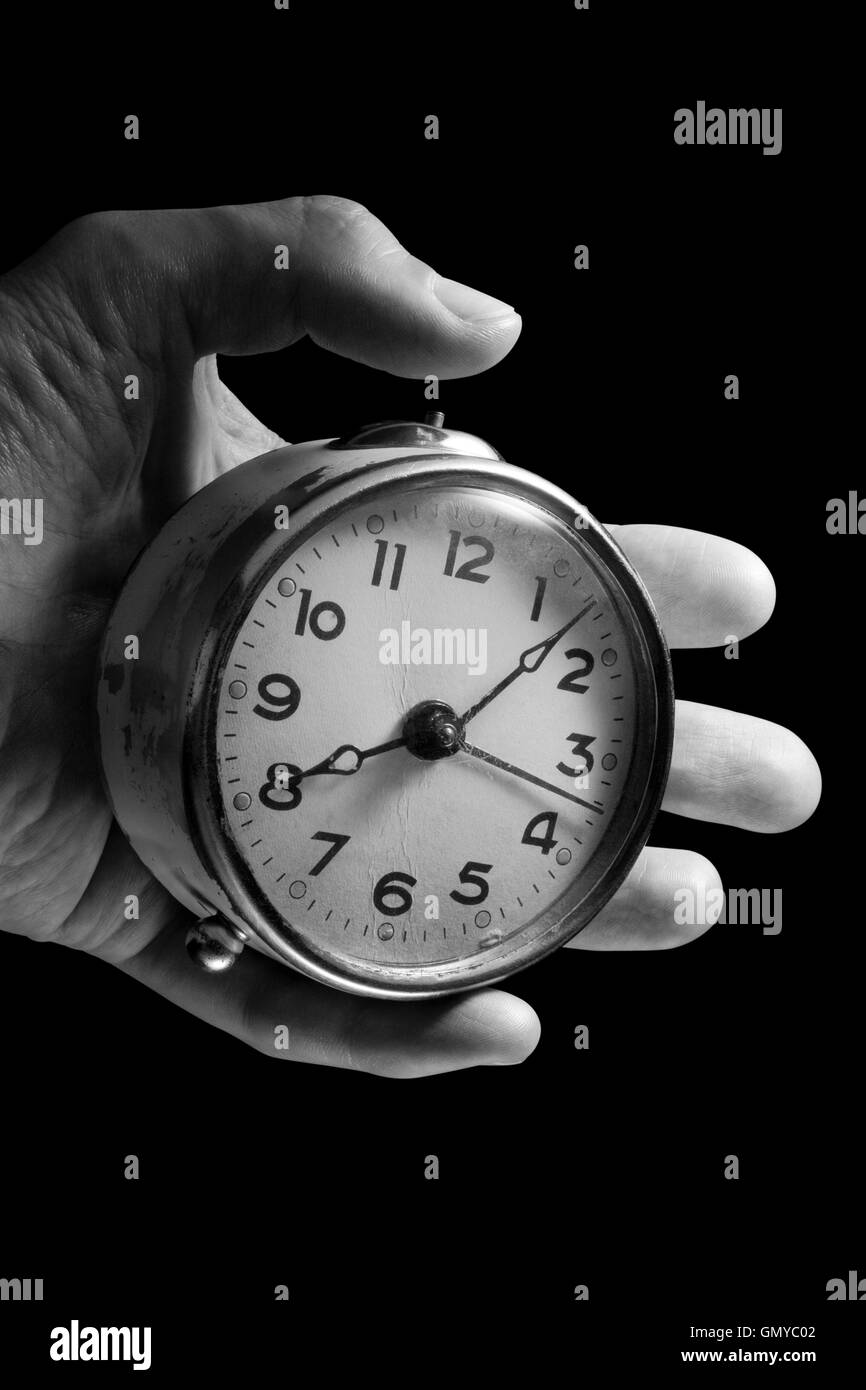 Alarm clock in hand Stock Photo - Alamy