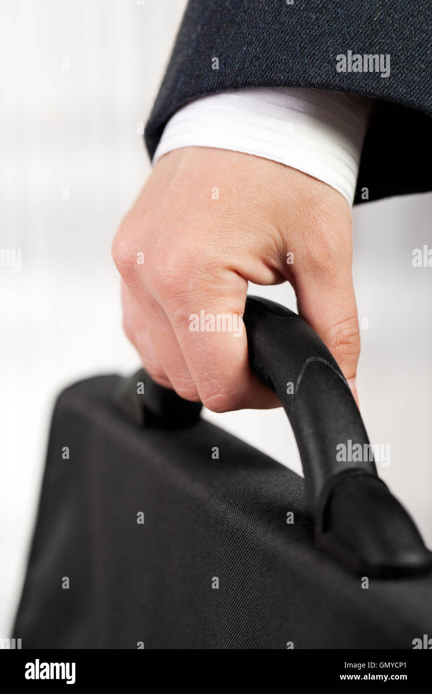 Hand holding briefcase Stock Photo - Alamy