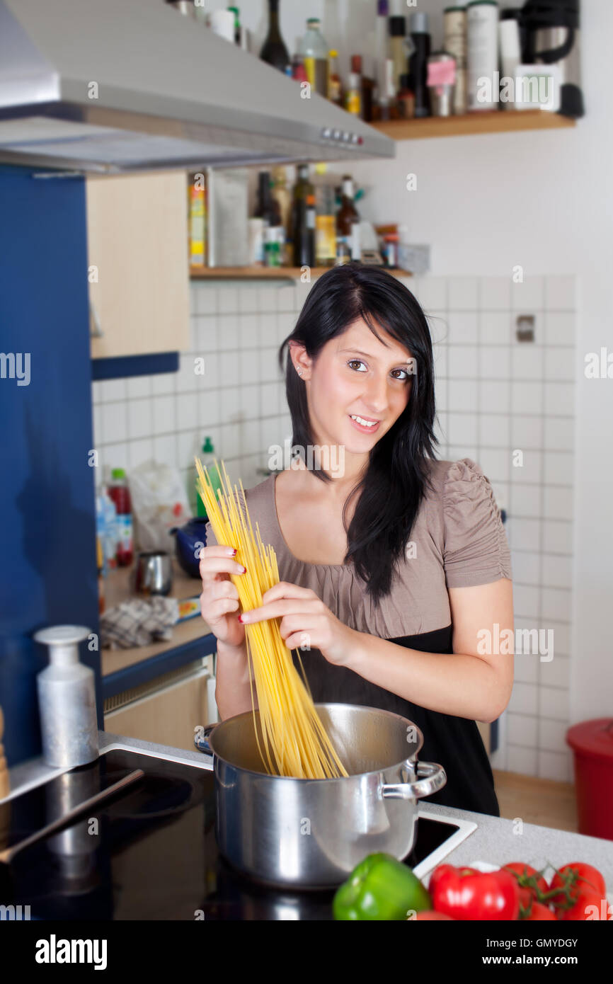 gorgeous young woman cooking spaghetti Stock Photo - Alamy