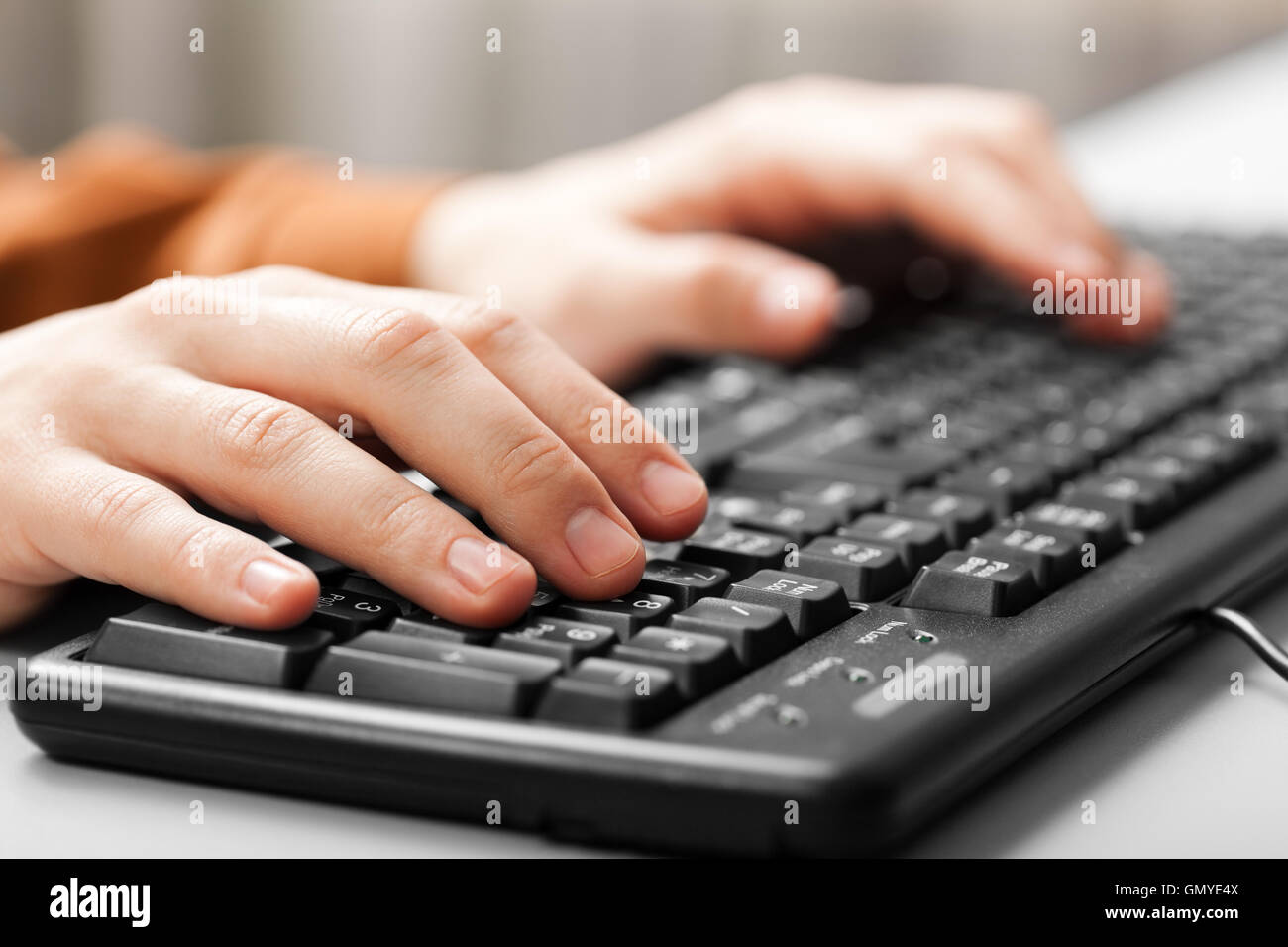 Hand typing computer keyboard Stock Photo - Alamy