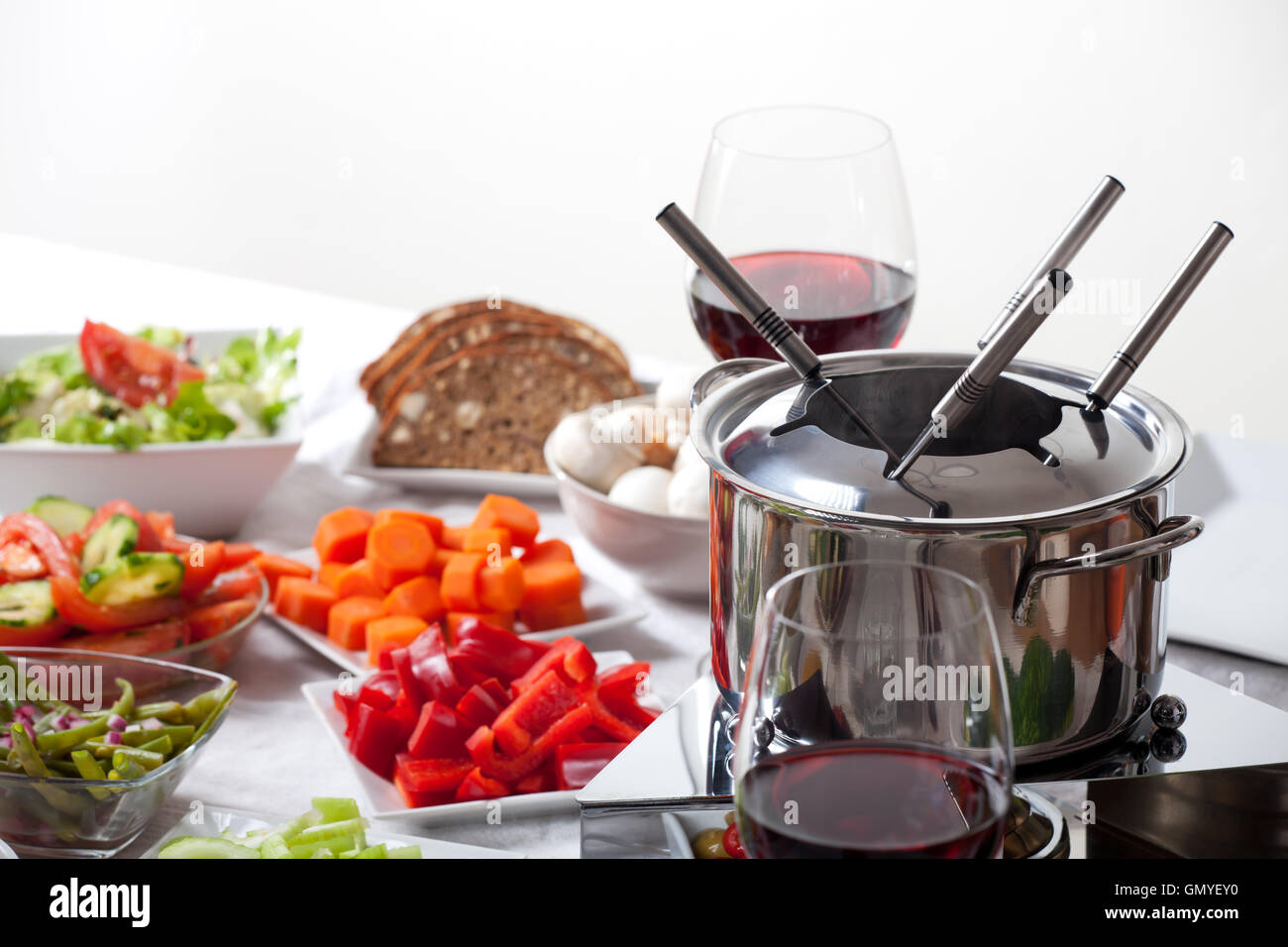 table with fondue set and ingredients Stock Photo - Alamy