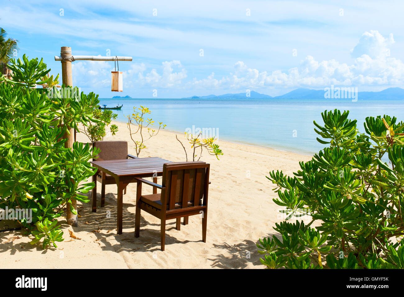 Chairs and table on beach near the sea Stock Photo - Alamy