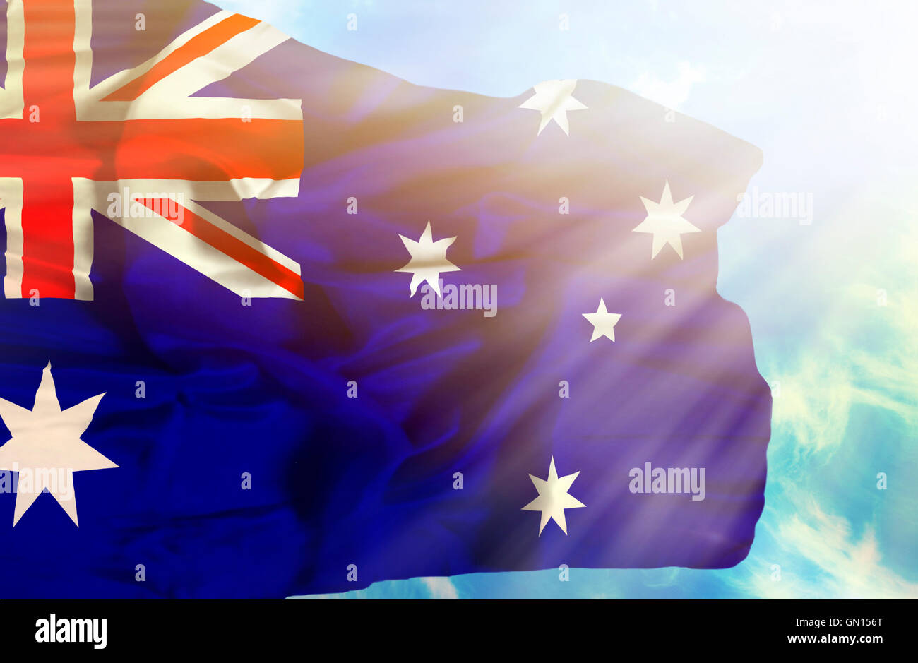 Australia waving flag against blue sky with sunrays Stock Photo - Alamy