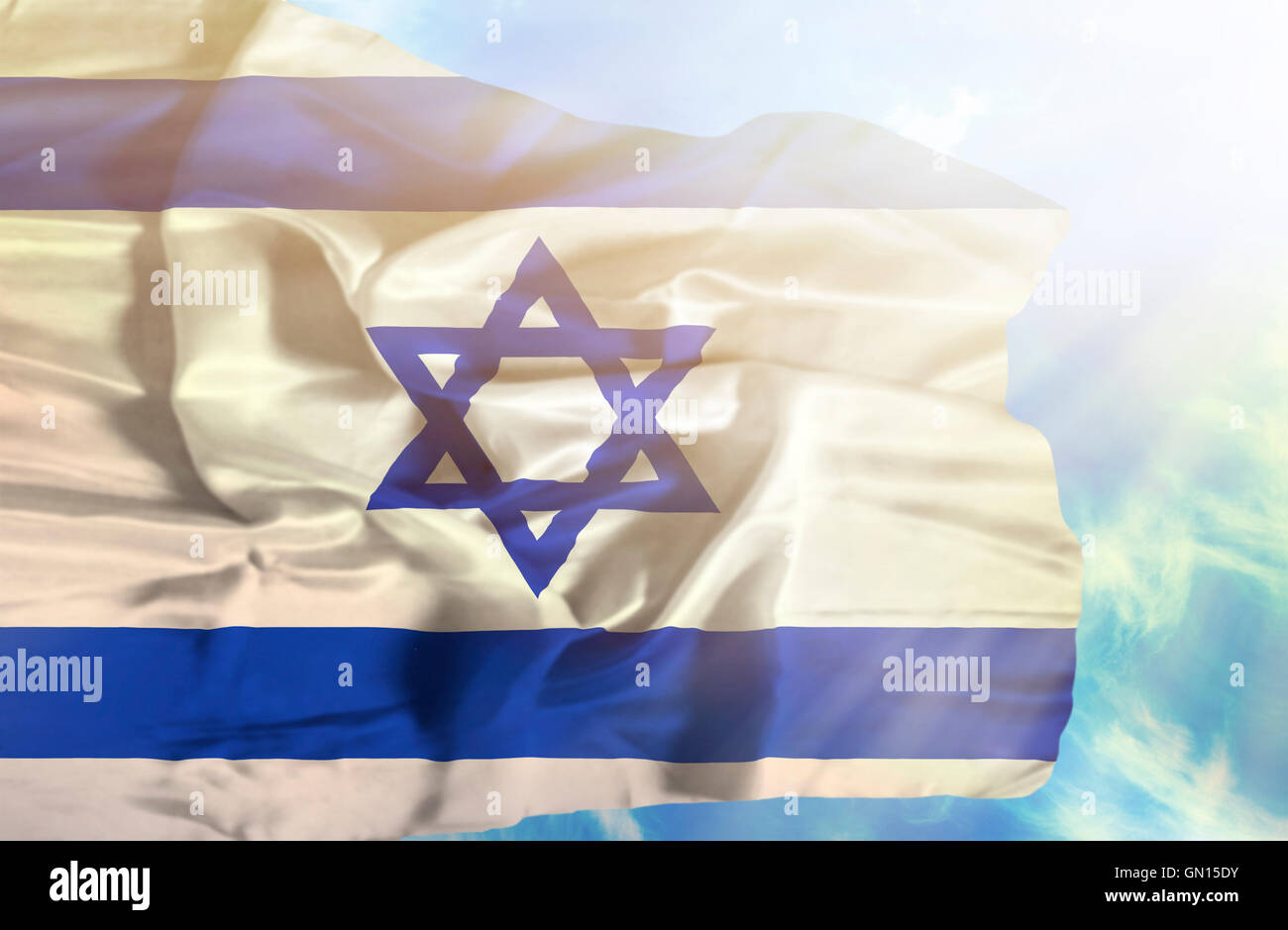 Israel waving flag against blue sky with sunrays Stock Photo - Alamy