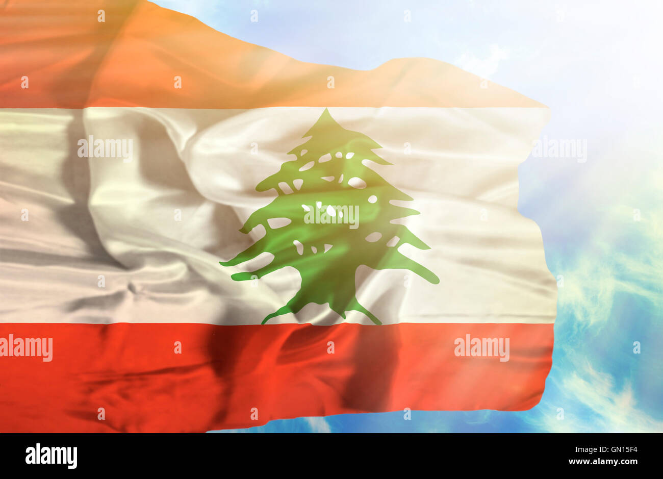 Lebanon waving flag against blue sky with sunrays Stock Photo - Alamy