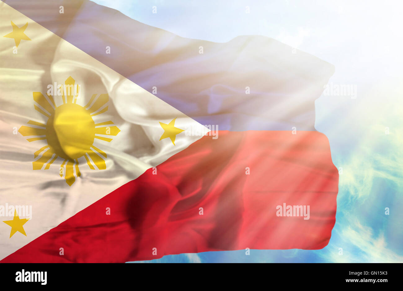 Phillipines waving flag against blue sky with sunrays Stock Photo - Alamy
