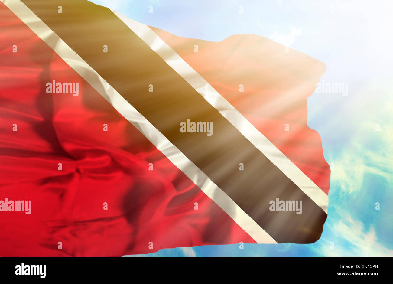 Trinidad and Tobago waving flag against blue sky with sunrays Stock ...