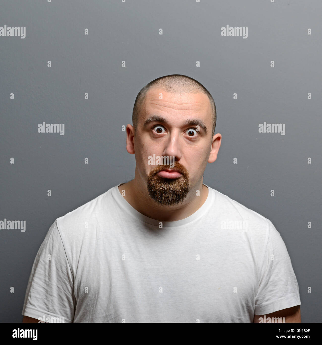 Portrait of a confused man against gray background Stock Photo - Alamy