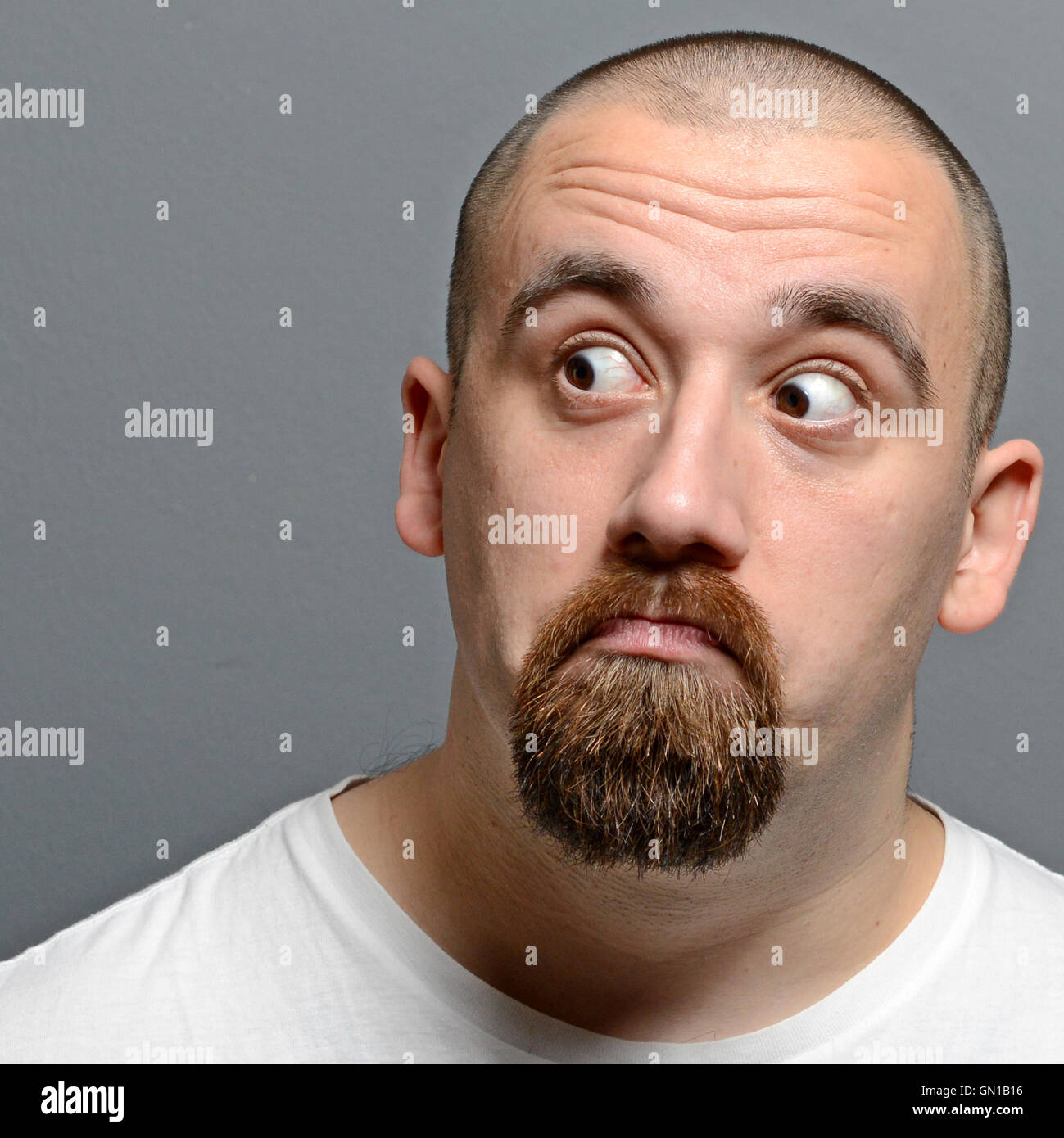 Portrait of a confused man against gray background Stock Photo - Alamy