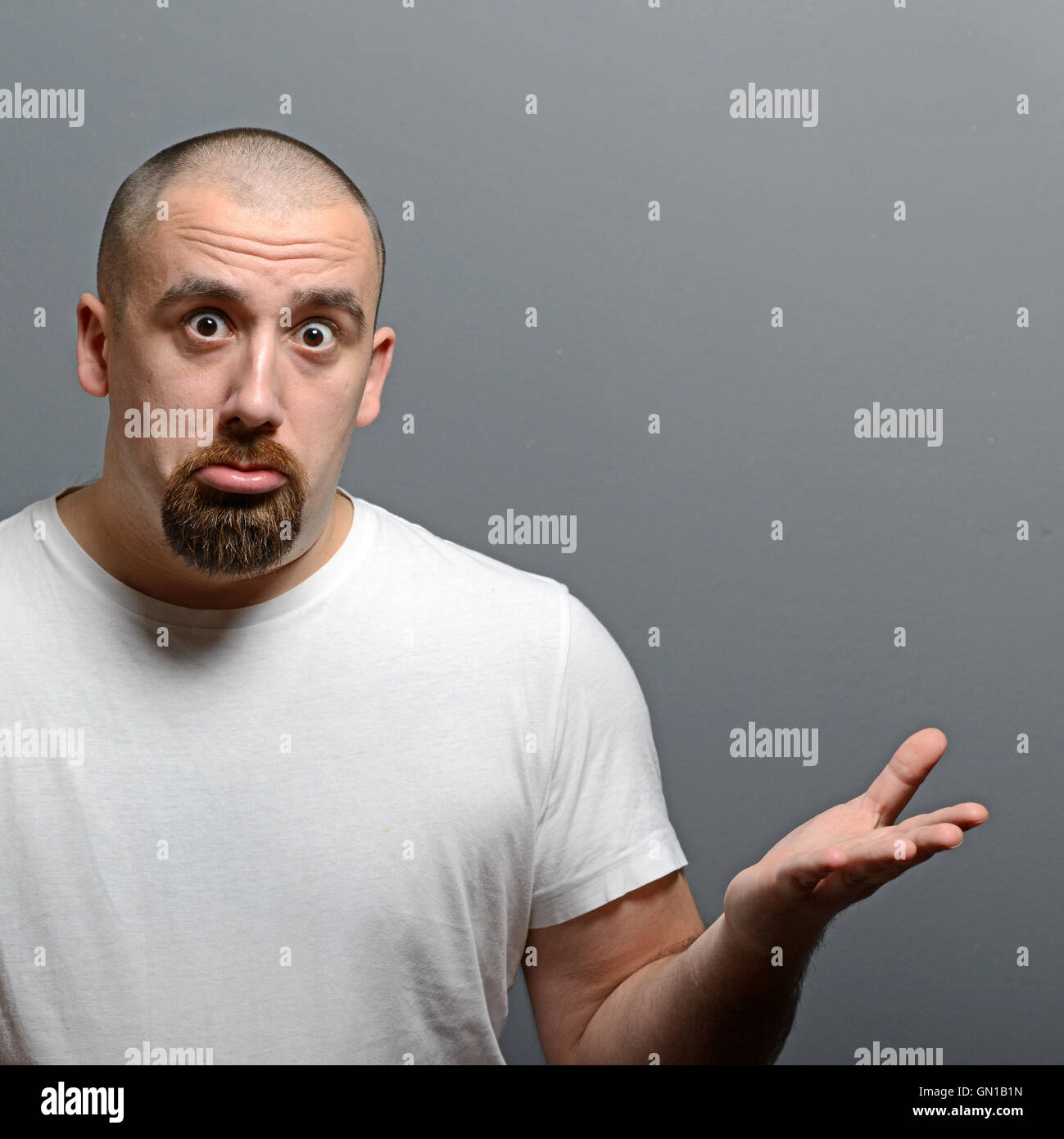 Portrait of a confused man against gray background Stock Photo - Alamy