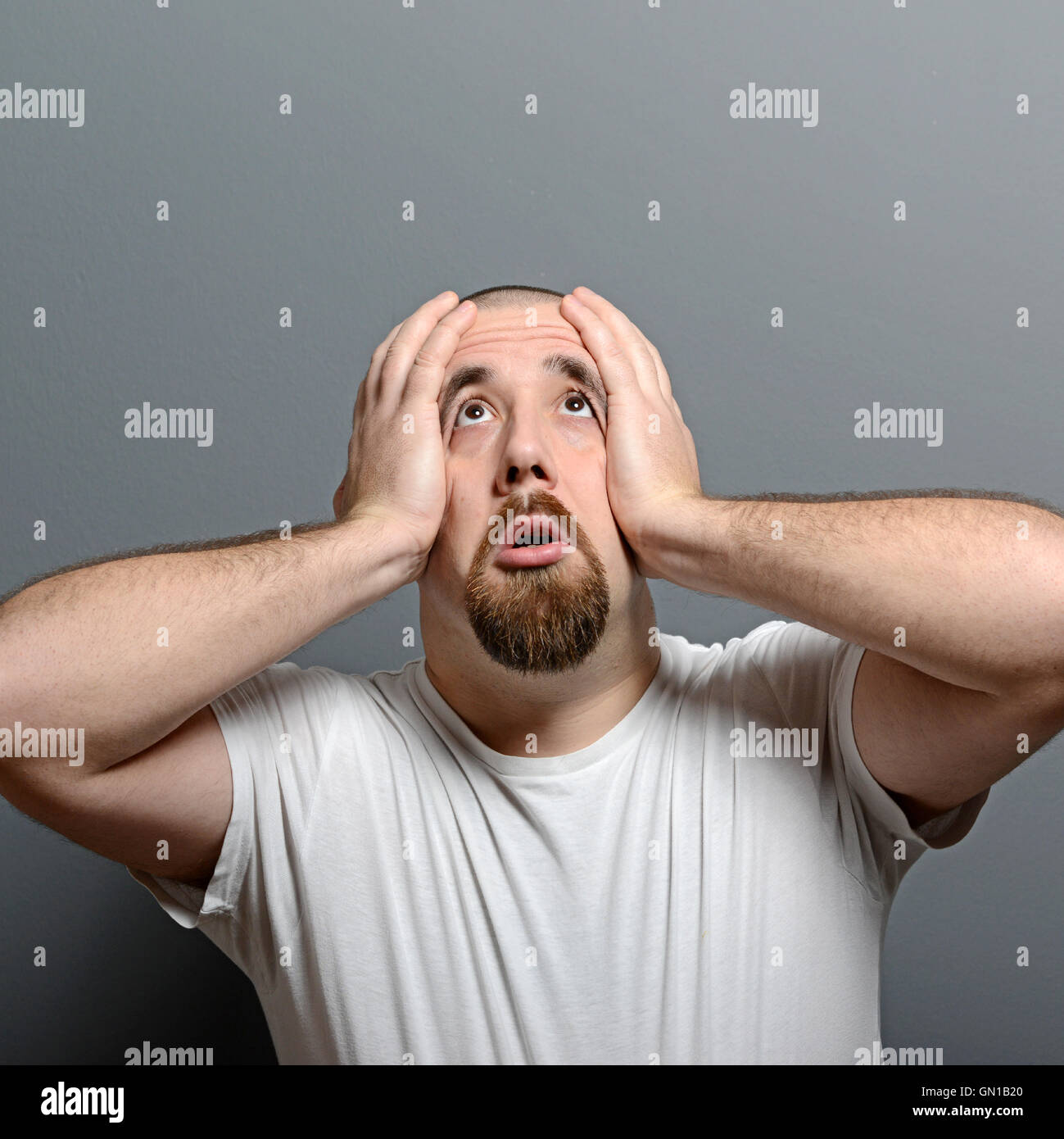 Portrait of a desperate man in shock against gray background Stock ...