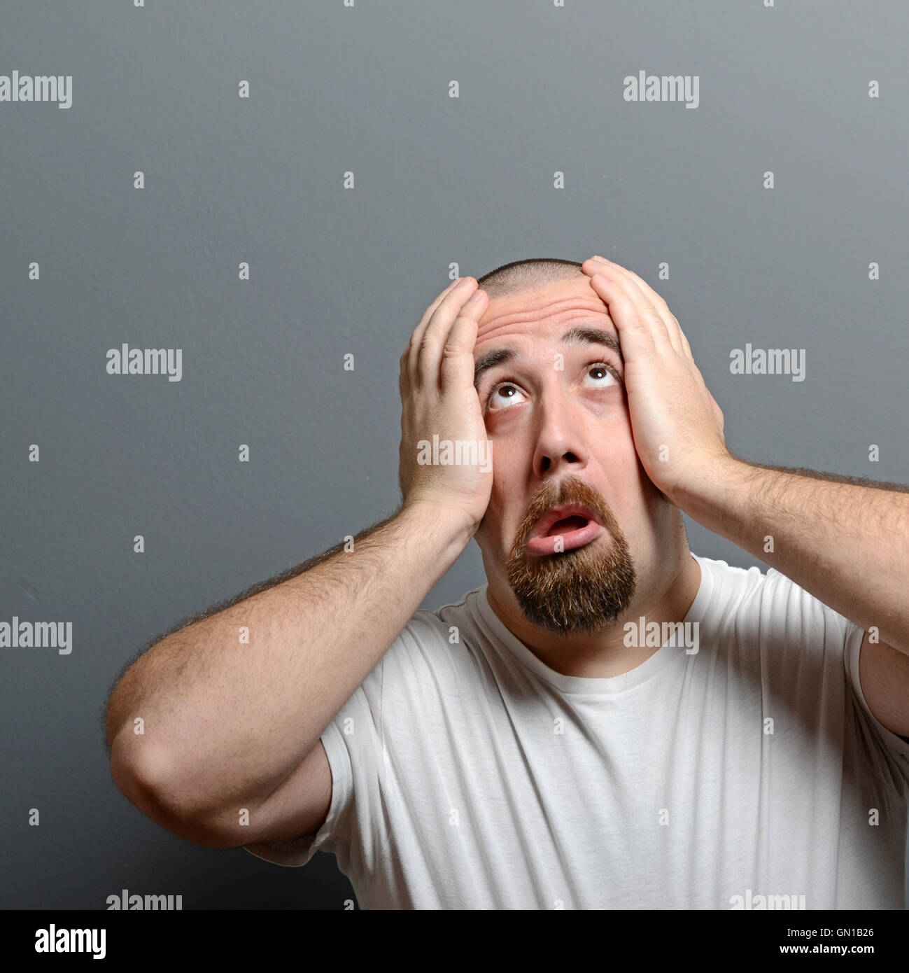 Portrait of a desperate man in shock against gray background Stock ...