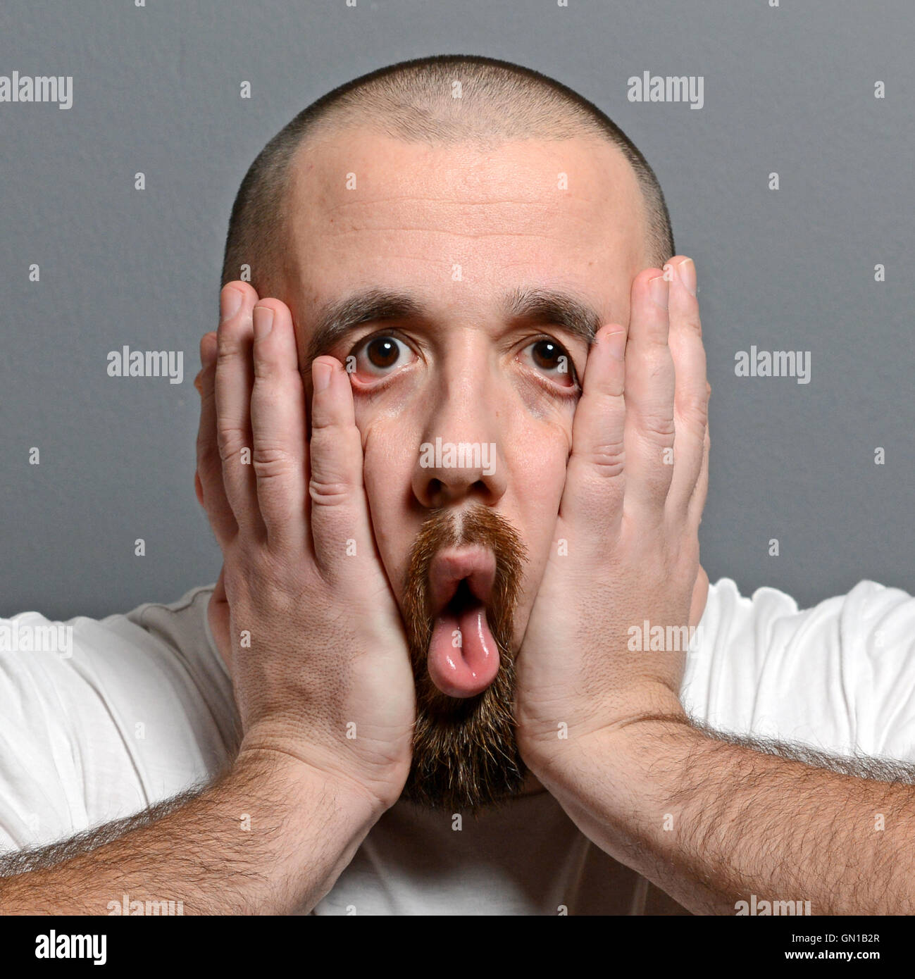 Portrait of a desperate man in shock against gray background Stock ...
