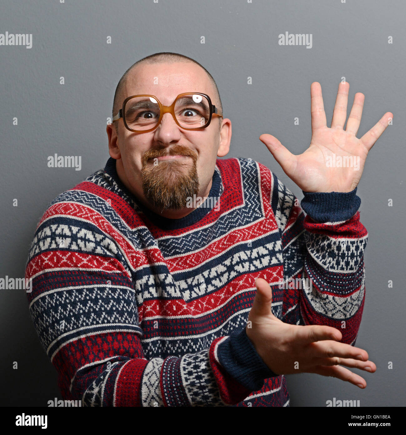 Portrait of a nerd clapping hands with glasses and retro sweater ...