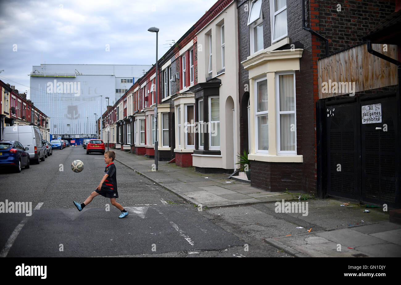 A young Liverpool fan playing football prior to the Premier League ...