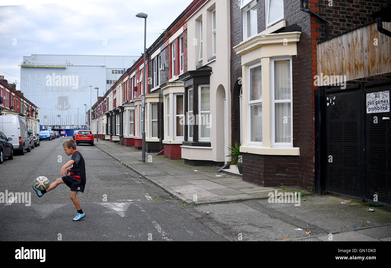 A young Liverpool fan playing football prior to the Premier League ...