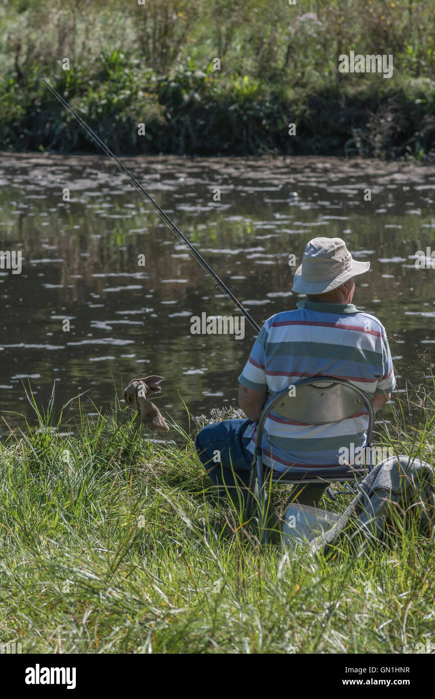 Man relaxing in chair fishing hi-res stock photography and images - Alamy