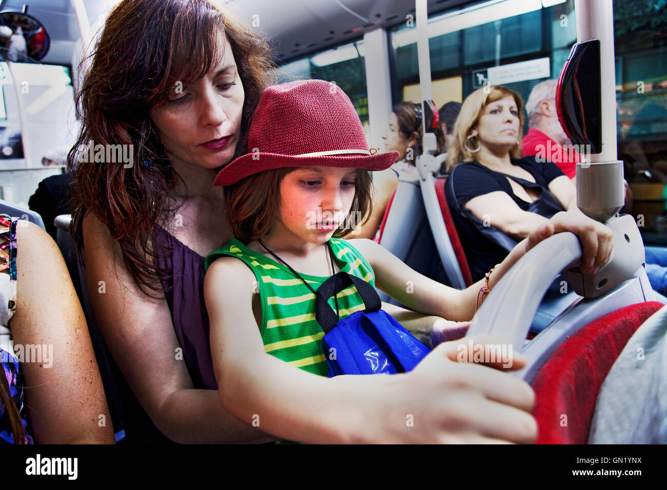 Mother and young son on bus at night, Barcelona, Spain Stock Photo - Alamy