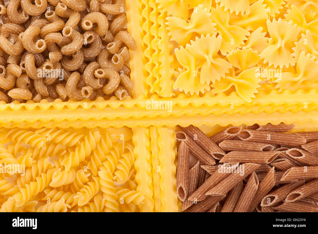 Assortment of italian pasta, four different varieties separated with ...