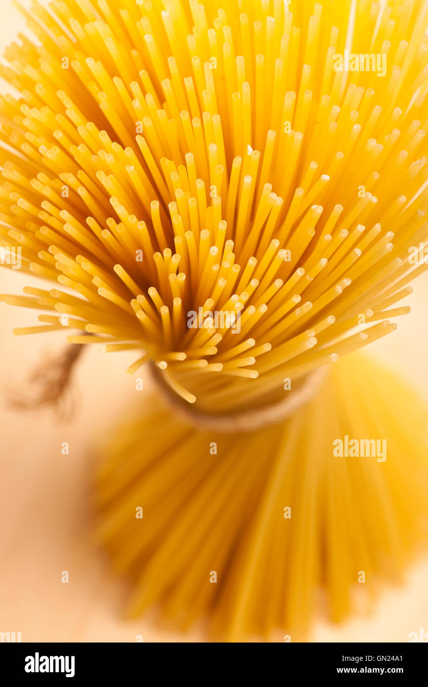 Wheat spaghetti standing tied with rope in bundle Stock Photo - Alamy